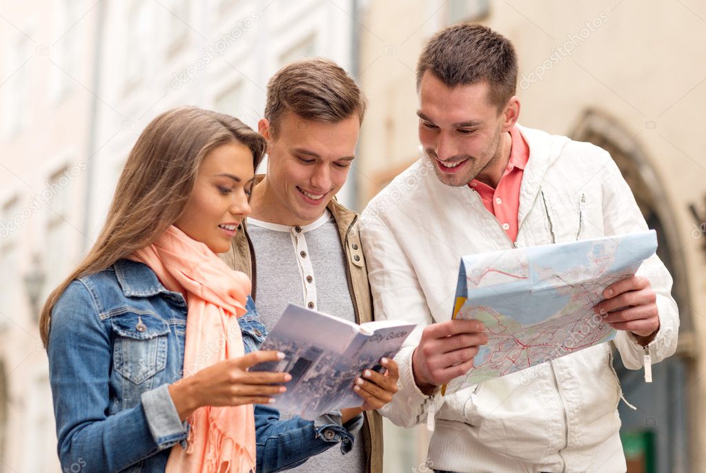 Group of smiling friends with city guide and map — Stock Photo © Syda ...