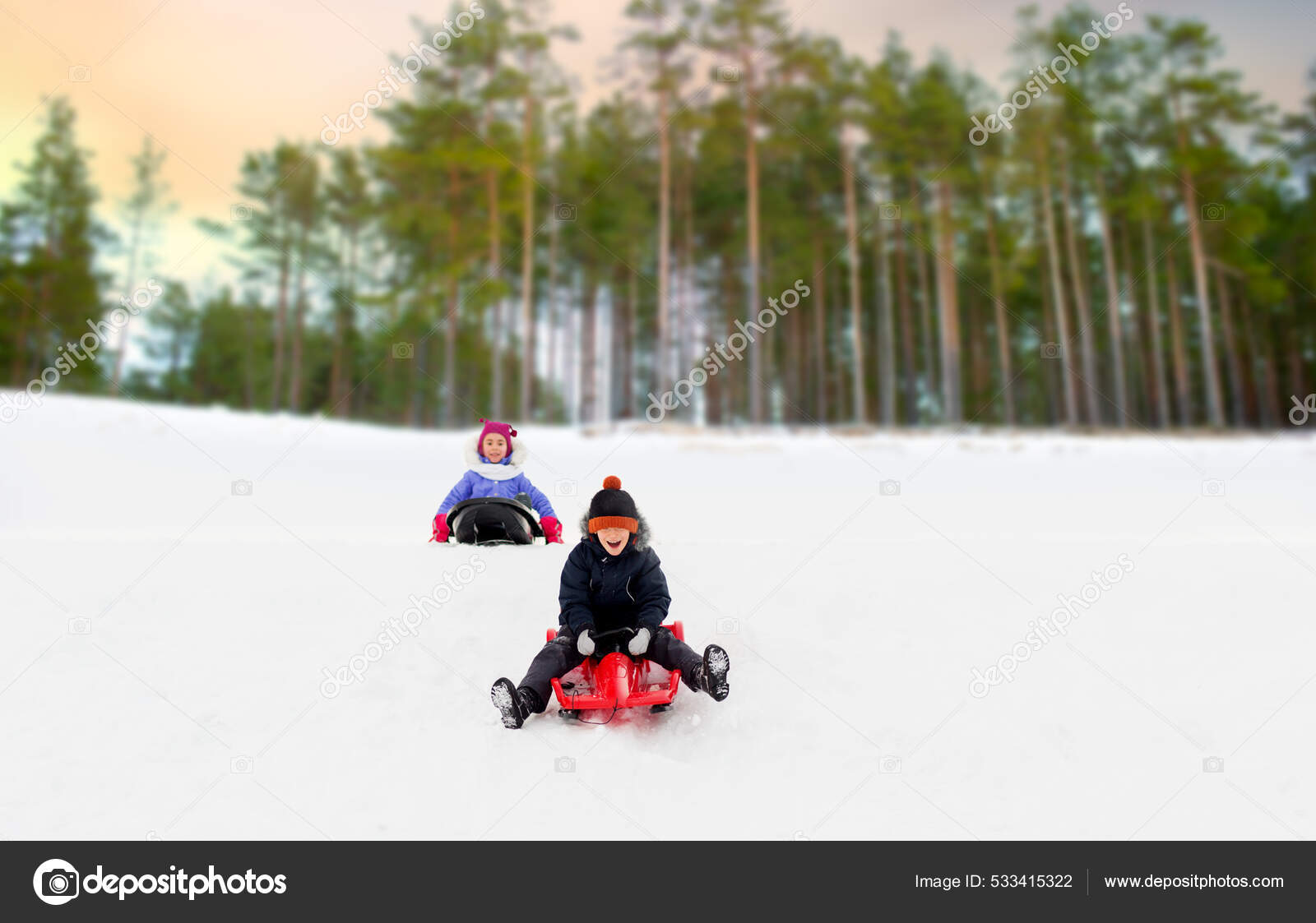 Happy kids sliding on sleds down hill in winter Stock Photo by ©Syda ...