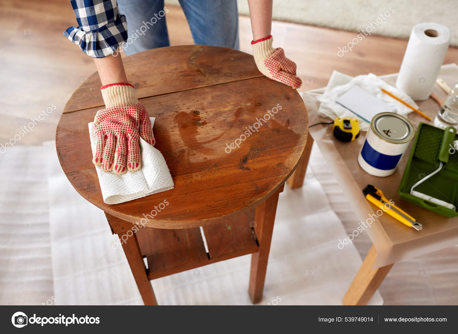 Woman cleaning old table surface with paper tissue Stock Photo by ©Syda ...