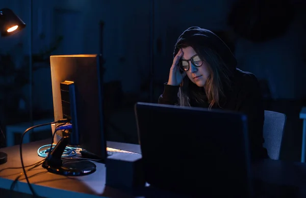 cybercrime, hacking and technology concept - female hacker in dark room ...