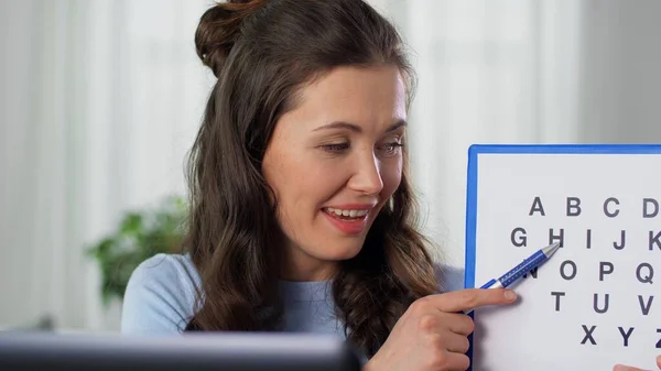 distant education, primary school and teaching concept - female teacher ...