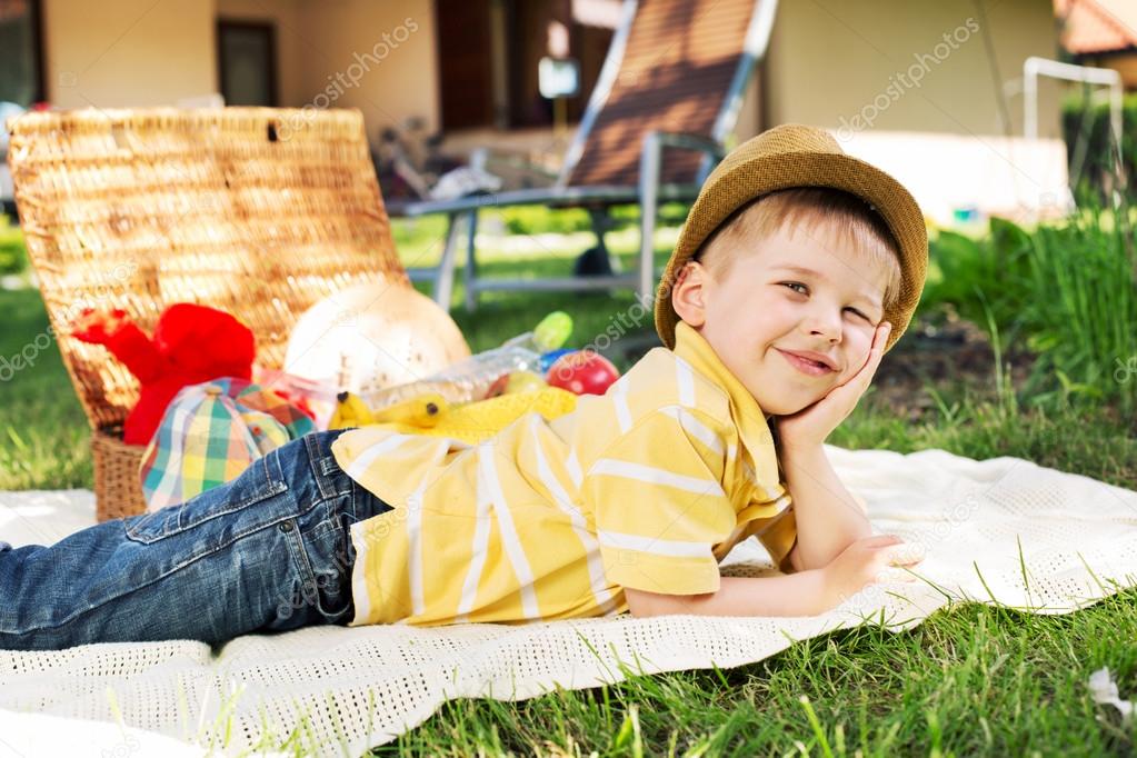 Little bit tired boy resting on the blanket — Stock Photo © konradbak ...
