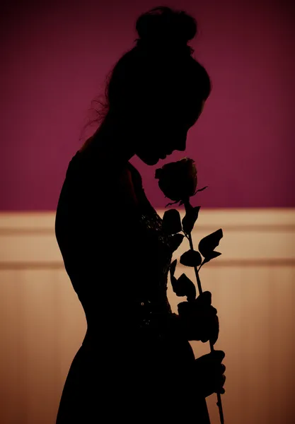 Shadow of woman holding a rose - Stock Image - Everypixel