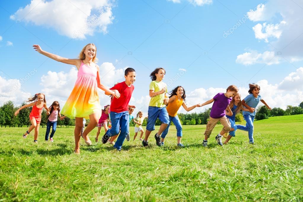 Large group of kids running in the park Stock Photo by ©serrnovik 32013221