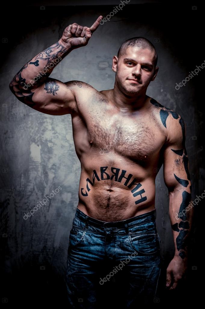 Muscular young man with many tattoos Stock Photo by ©amoklv 14828435