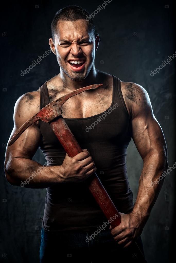 Muscular man holding pickaxe — Stock Photo © amoklv #28074763