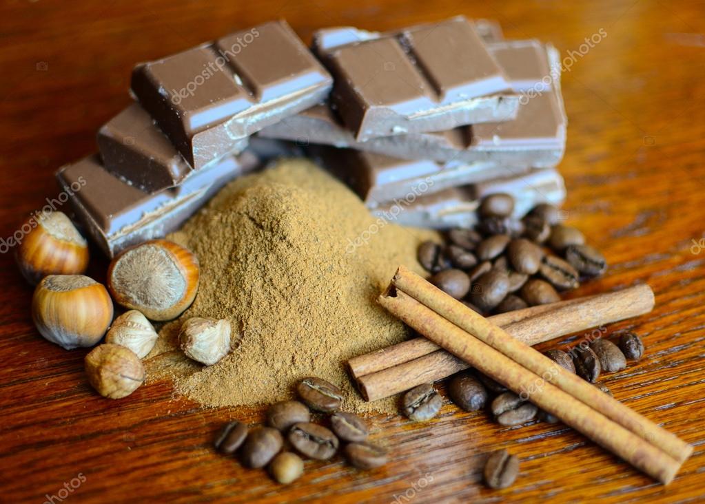 Chocolate background with hazelnuts and cocoa sticks Stock Photo by ...