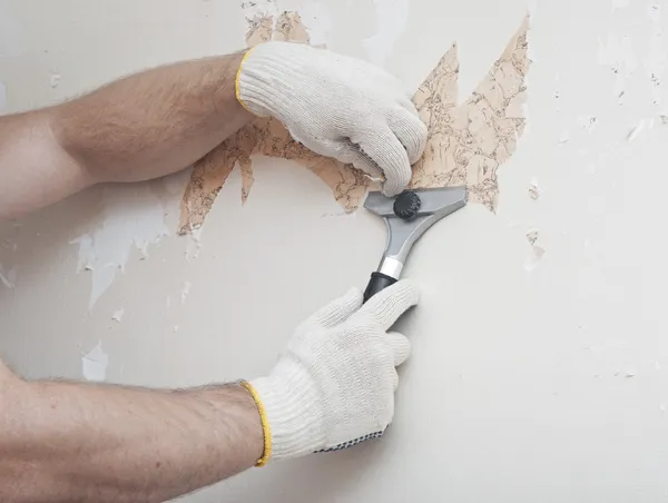 Hand removing wallpaper from wall Stock Photo by ©inxti74 36777077