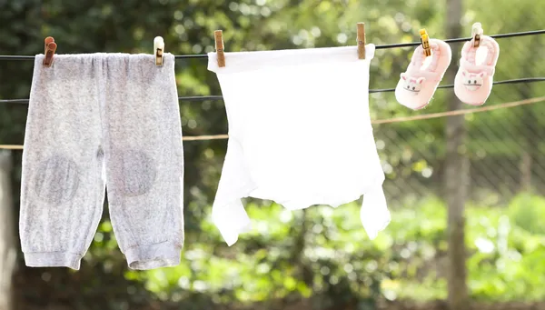 Baby clothes hanging Stock Photos, Royalty Free Baby clothes hanging ...