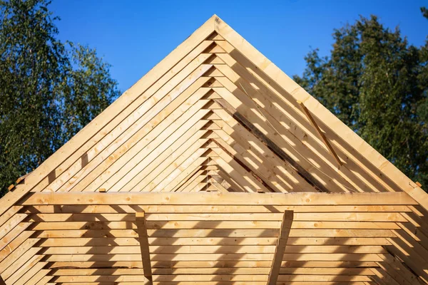 Roofing construction. Wooden roof frame during house construction ...