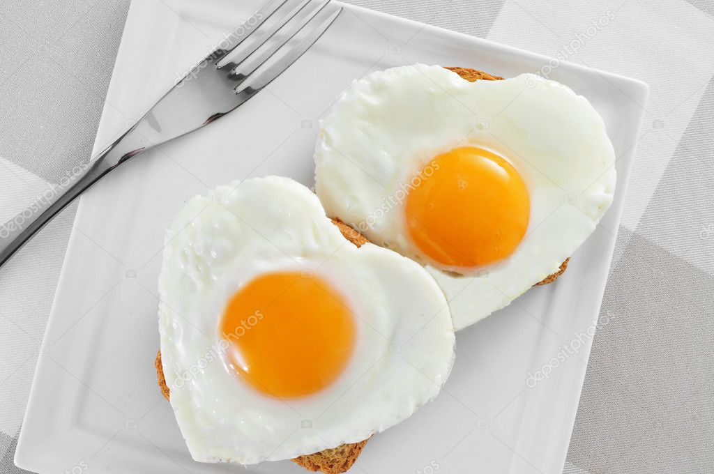 Heart-shaped fried eggs Stock Photo by ©nito103 47620739