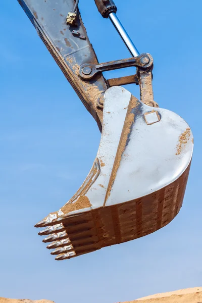 Excavator arm and scoop digging dirt at construction site — Stock Photo ...