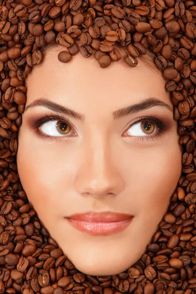 Woman face in the coffee beans — Stock Photo © Dualshock #49593013