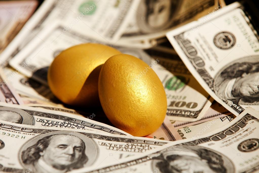 Gold eggs on money background Stock Photo by ©nataiki 23125250