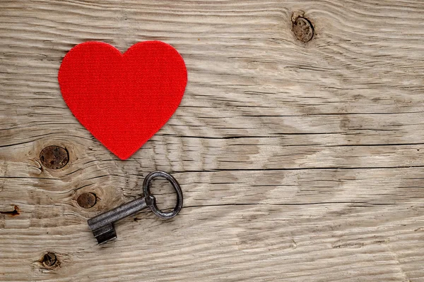 'Key to My Heart' love concept, with gold heart shape key and red heart ...