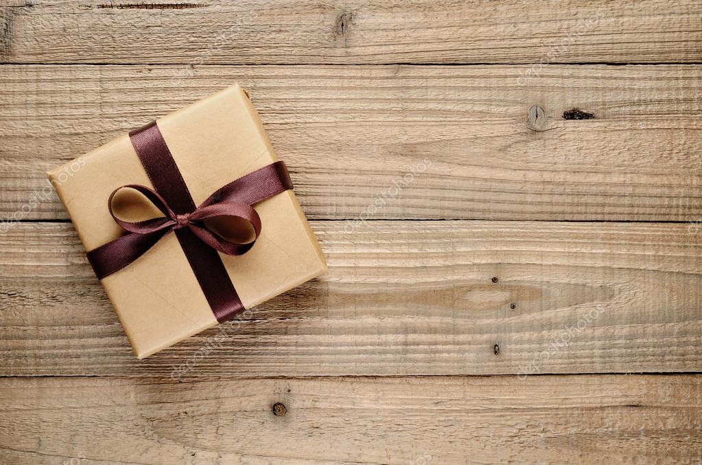 Vintage gift box with bow on wooden background — Stock Photo ...