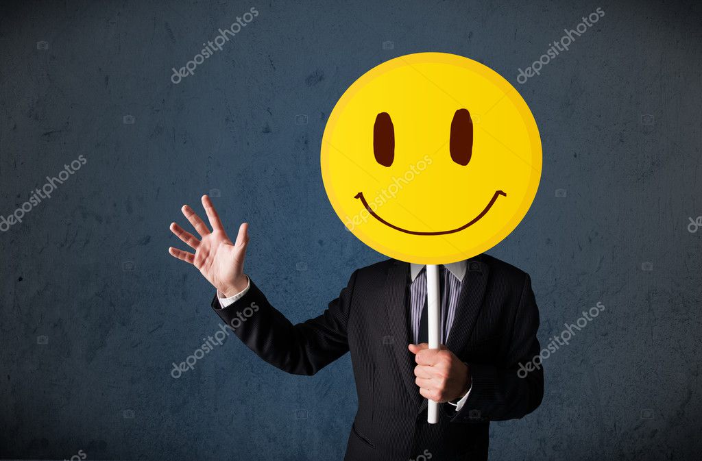 Businessman holding a smiley face emoticon — Stock Photo © ra2studio ...