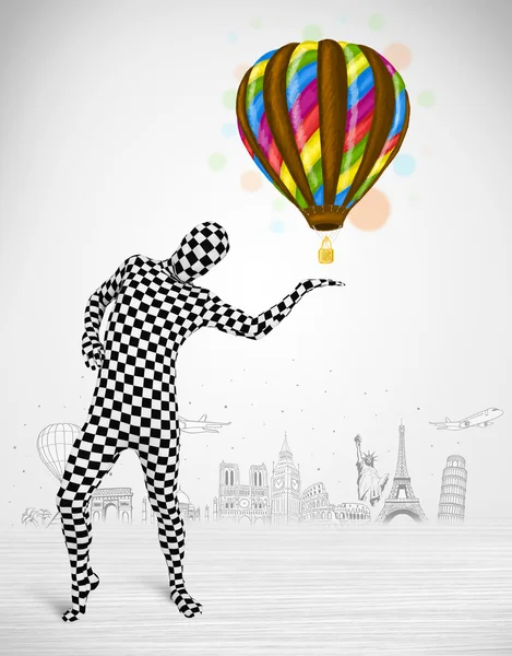 man in full body suit holding balloon - Stock Image - Everypixel
