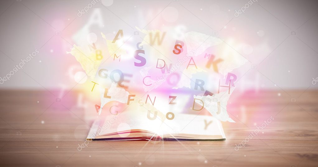 Open book with glowing letters on concrete background — Stock Photo ...