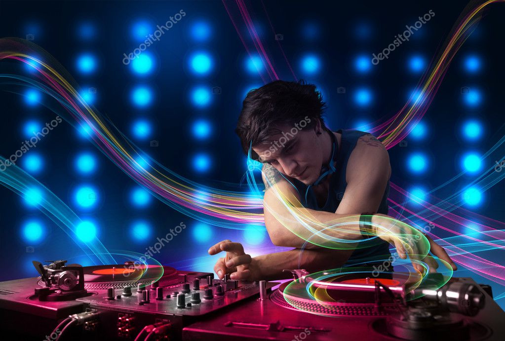 Young Dj mixing records with colorful lights — Stock Photo © ra2studio ...