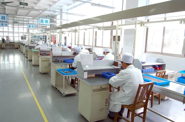 Production line workers — Stock Photo © zhanglianxun #19451595