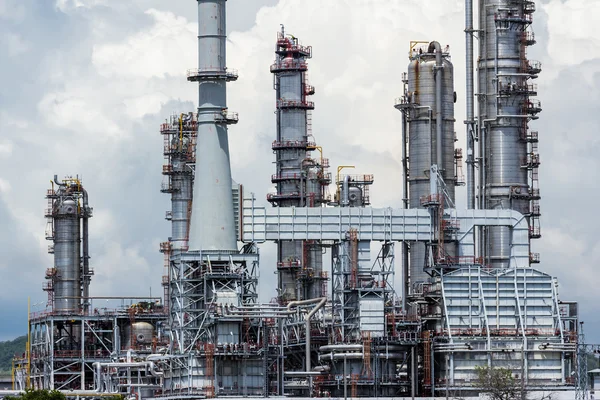 Oil refinery plant against blue sky — Stock Photo © tungphoto #19533907