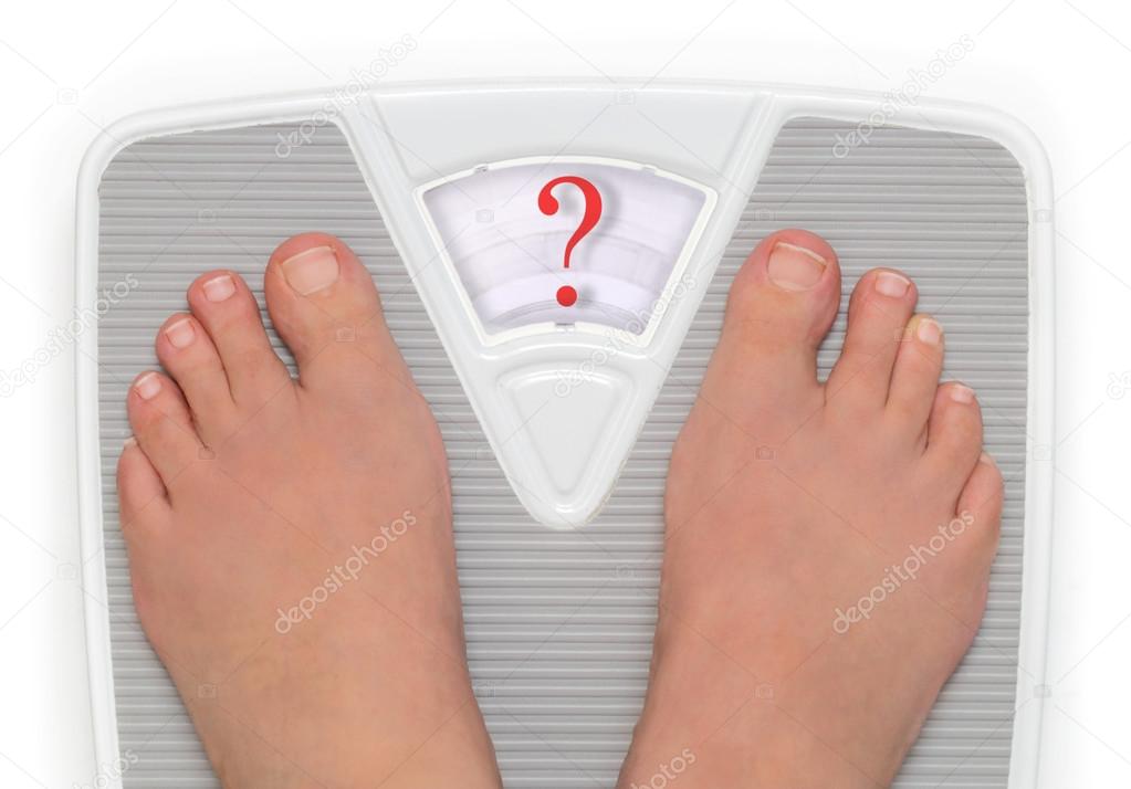 Female feet on bathroom scale with question mark symbol Stock Photo by ...