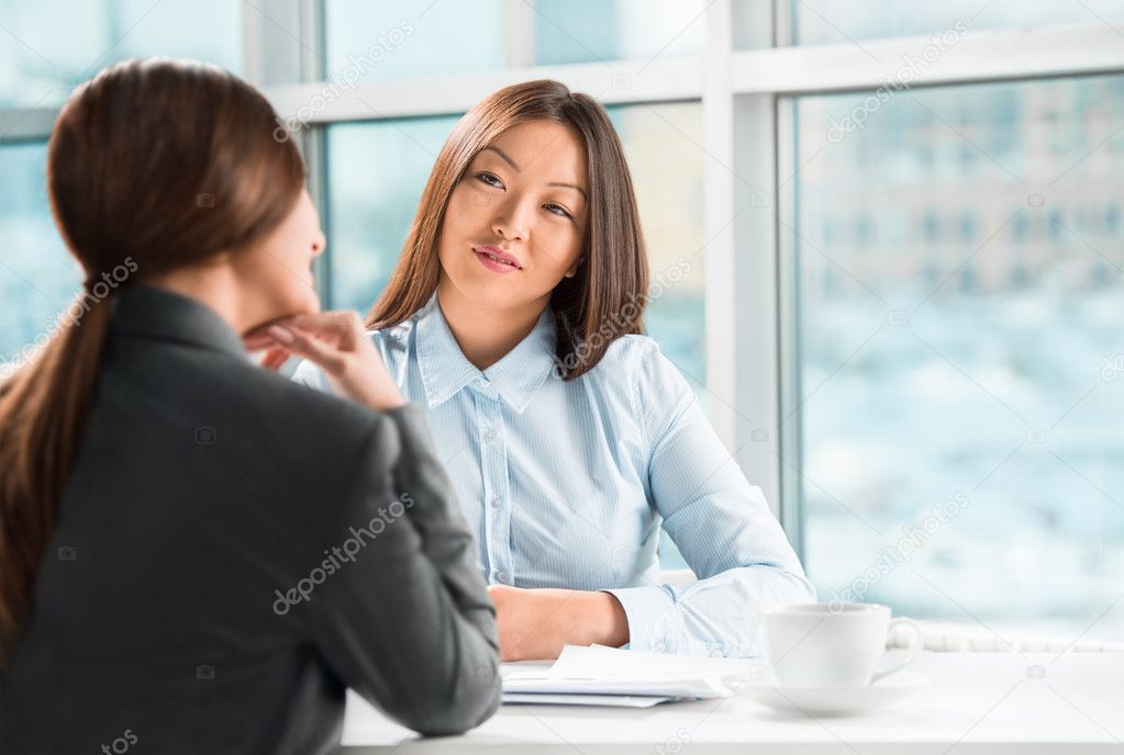 Two business women talking and signing contract at office — Stock Photo ...