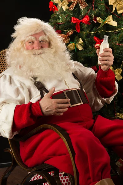 Happy Santa Claus drinking milk from glass bottle — Stock Photo ...
