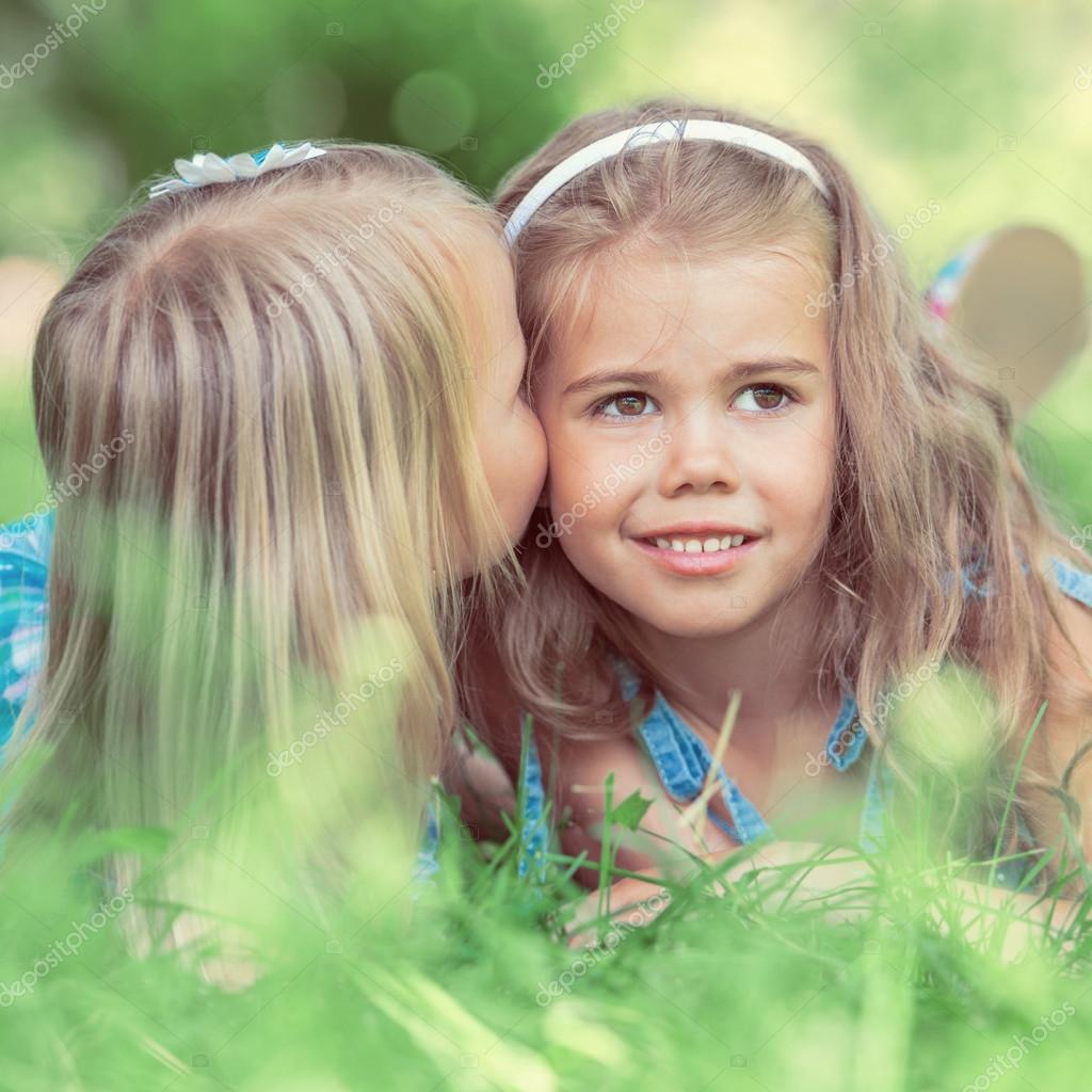 Happy children relaxing on grass in summer park — Stock Photo © HASLOO ...