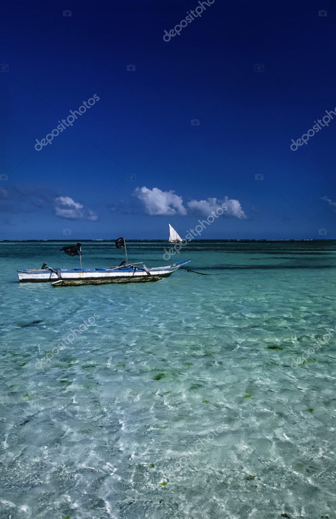 Kenya, Indian ocean, Malindi, view of a local fishing boat in shallow ...