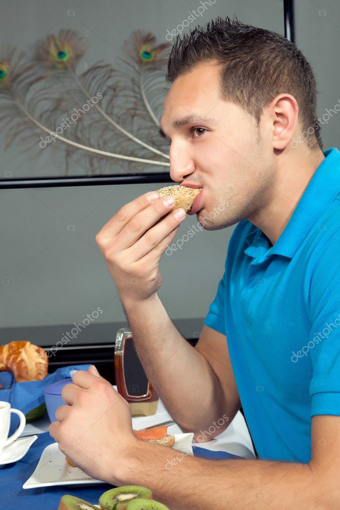 Young man eating breakfast Stock Photo by ©dteurope 28375703