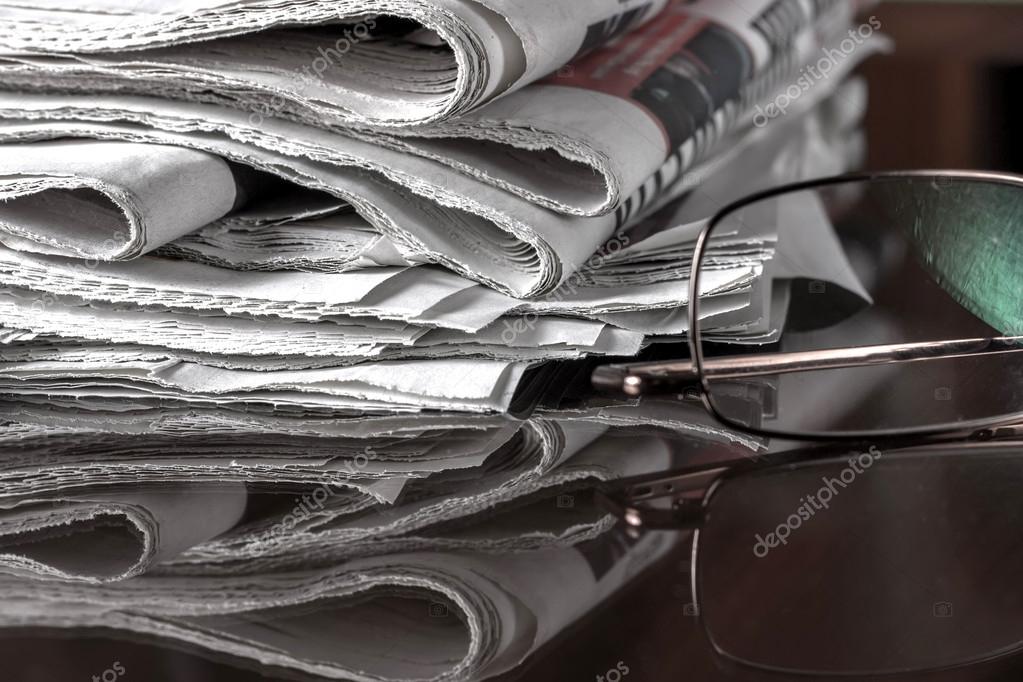 Pile of newspaper & glasses Stock Photo by ©librakv 19169725