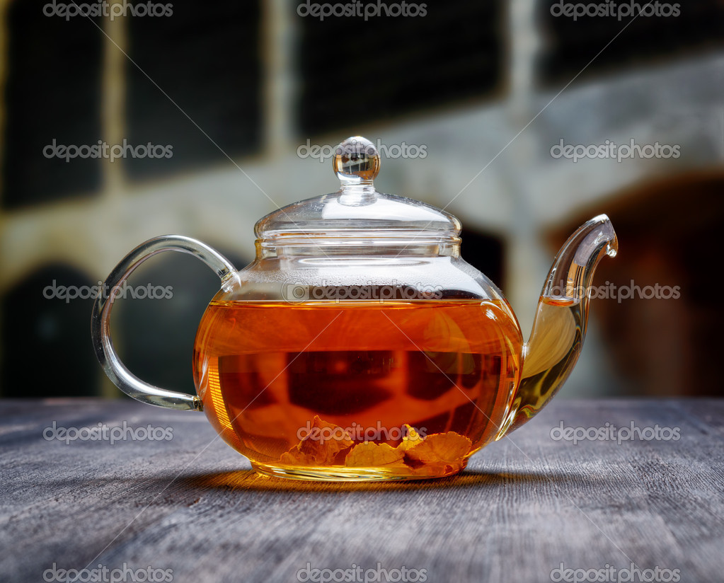 Teapot of fresh tea on wooden table Stock Photo by ©efired 31386643