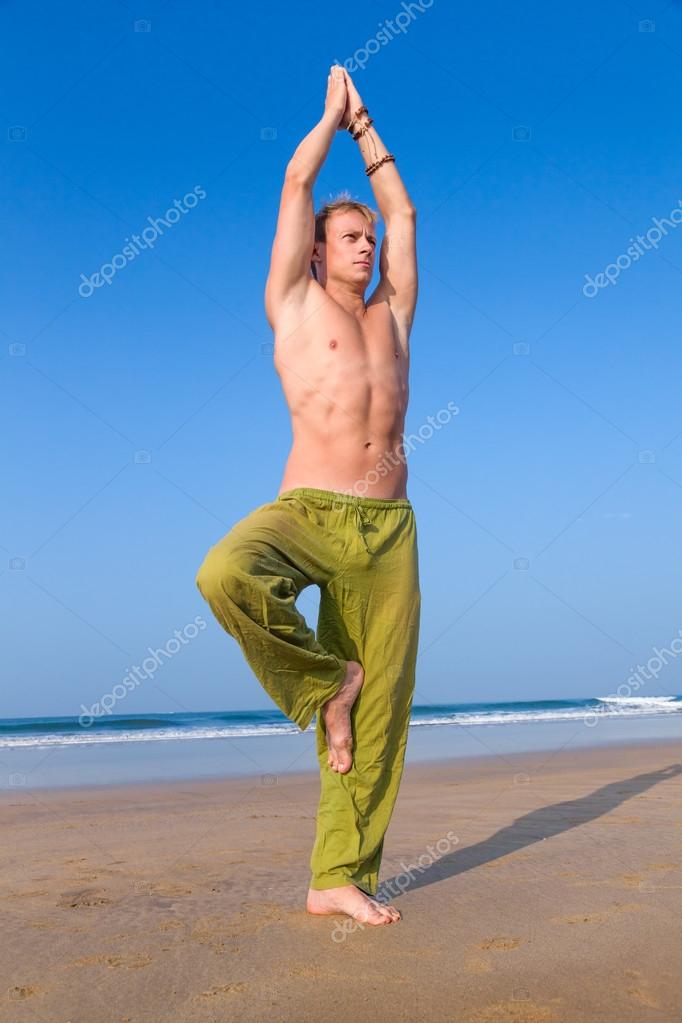Man meditating in tree pose Stock Photo by ©Avesun 46986313