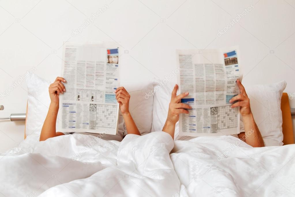 Reading a newspaper in bed — Stock Photo © ginasanders #14877317