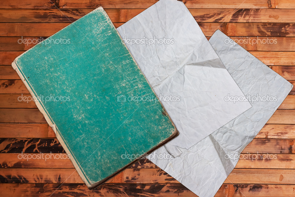 Vintage green book and papers on a wooden background Stock Photo by ...