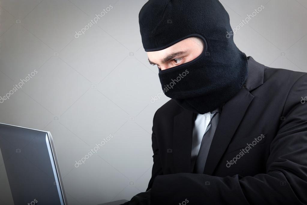 Computer hacker in suit and tie over grey background Stock Photo by ...
