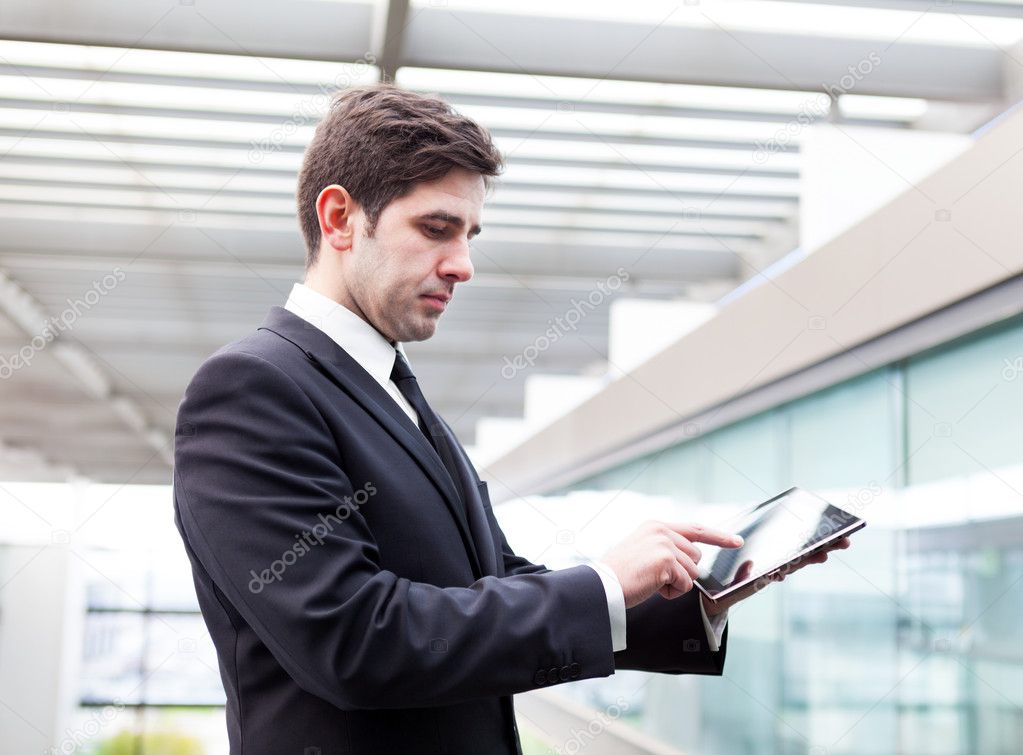 Young businessman using his digital tablet at the office Stock Photo by ...