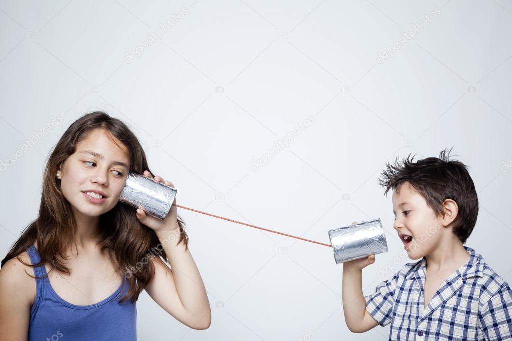 Kids using a can as telephone — Stock Photo © cristovao #48453619