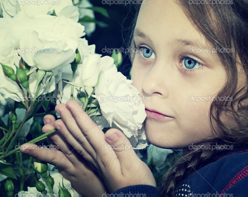 Child smelling flowers — Stock Photo © gurinaleksandr #44497503
