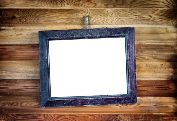 Old vintage wooden frame with empty space for text hanging on the wall ...