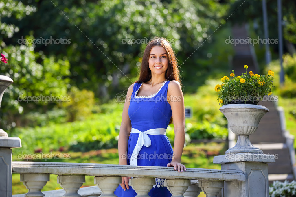 Girl standing at railing of stone — Stock Photo © jenoche #36493971