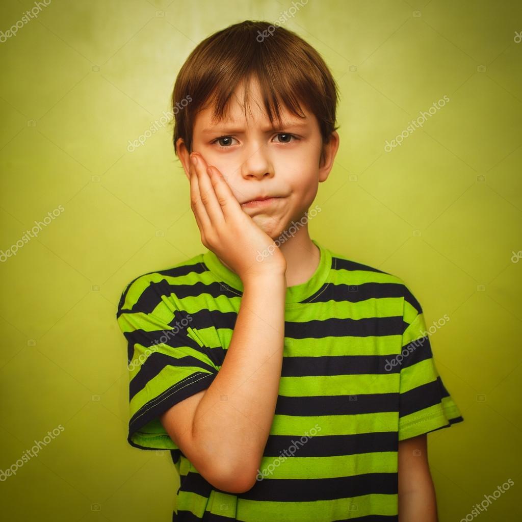Young kid boy child toothache pain in mouth, dental pain, holdin ...