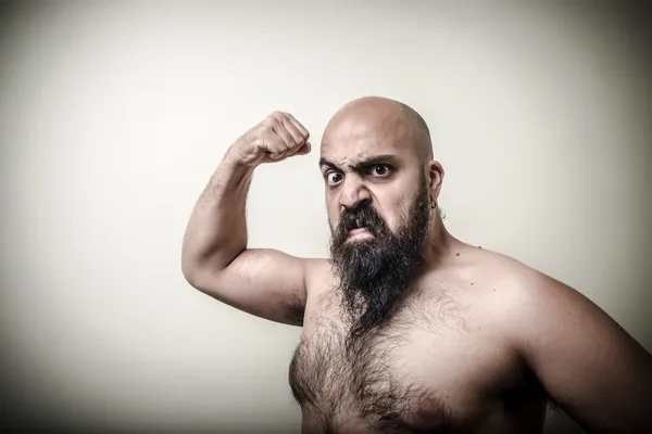 Super power angry muscle bearded man - Stock Image - Everypixel