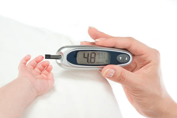 Measuring glucose level blood test from diabetes child baby Stock Photo ...