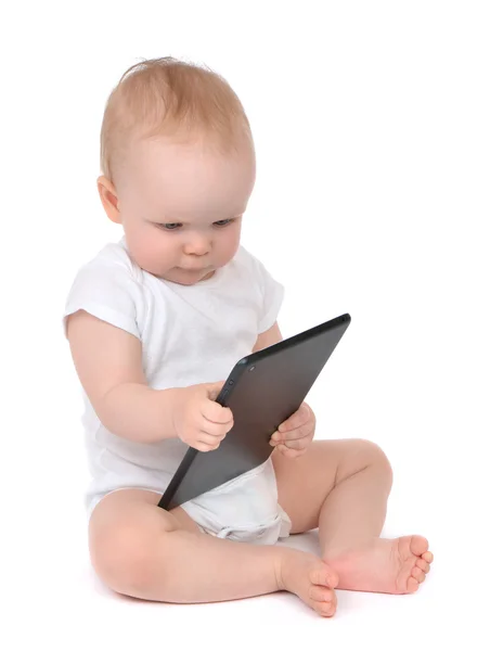 Infant child baby toddler sitting and typing digital tablet mobi Stock ...