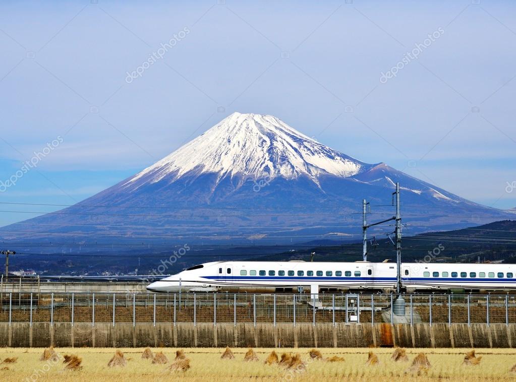 A bullet train passes below Mt. Fuji in Japan. – Stock Editorial Photo ...
