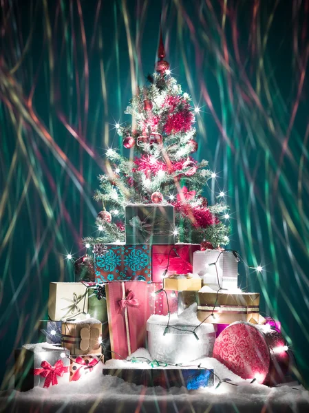 Brightly lit christmas tree with presents — Stock Photo © shotsstudio ...