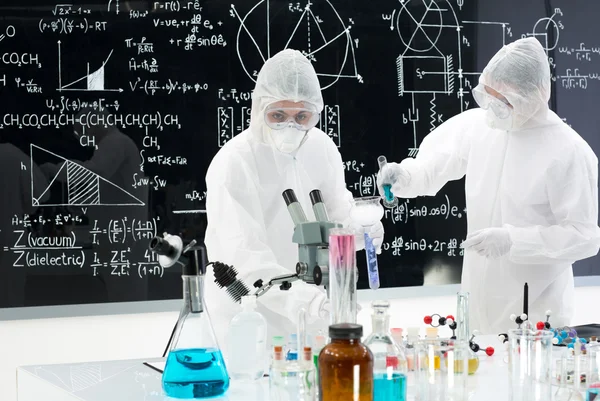 Scientists manipulating lab tools - Stock Image - Everypixel